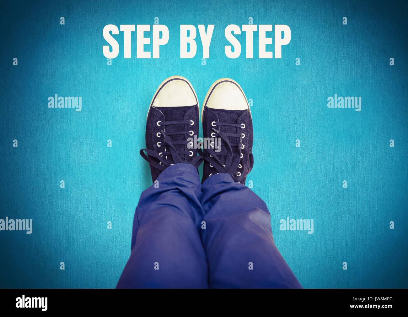 Digital composite of Step by step text and Black shoes on feet with ...