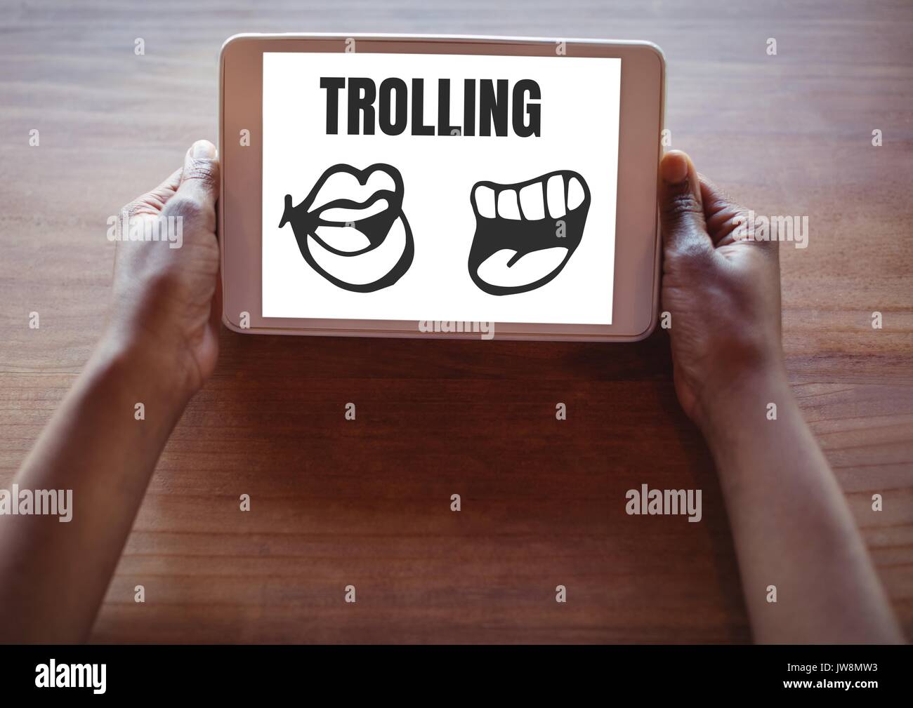 Digital composite of Trolling text and mouth cartoons on tablet in ...