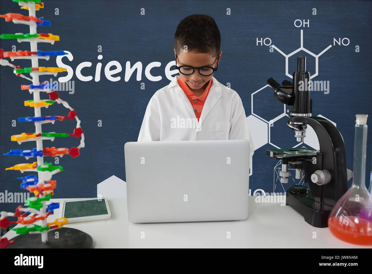 Digital composite of Student boy at table using a computer against blue ...
