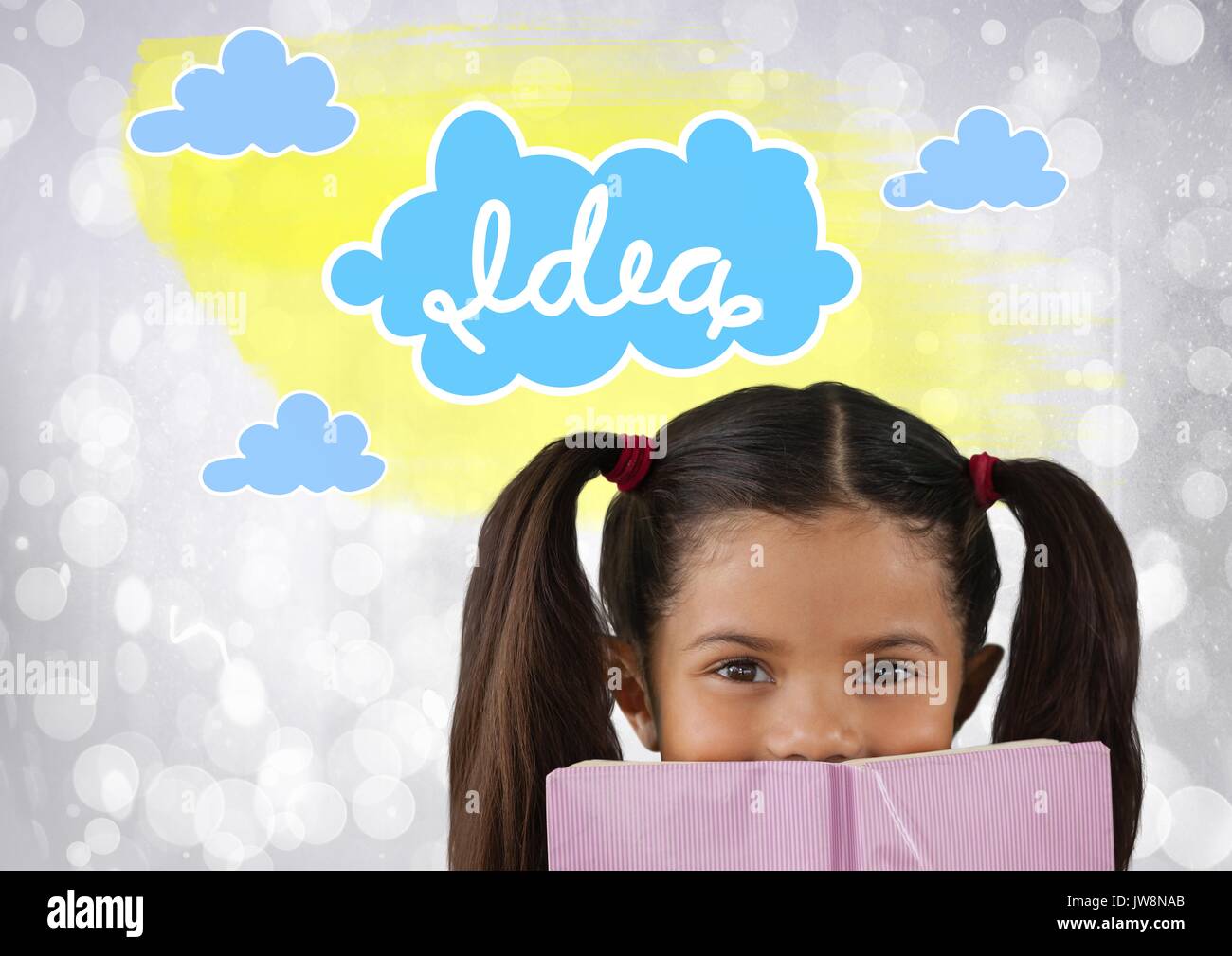 Digital composite of Girl reading with colorful idea graphics clouds ...