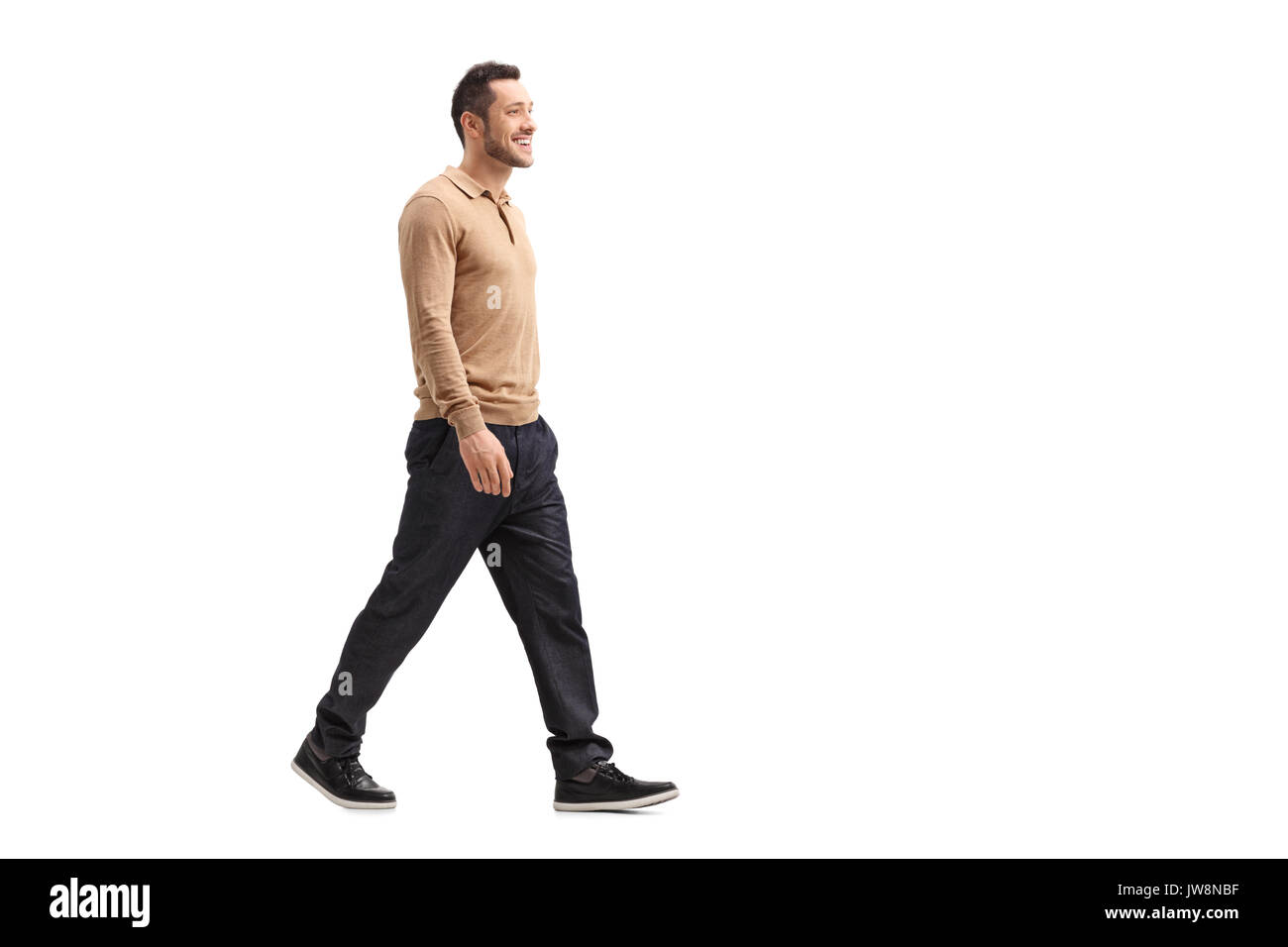 Full length profile shot of a young guy walking isolated on white ...