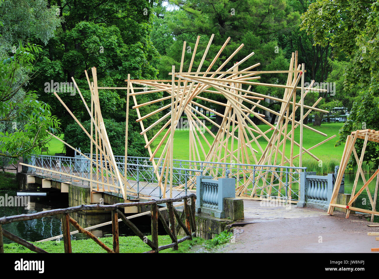 Construction of a wooden structure on a park bridge for an event with ...