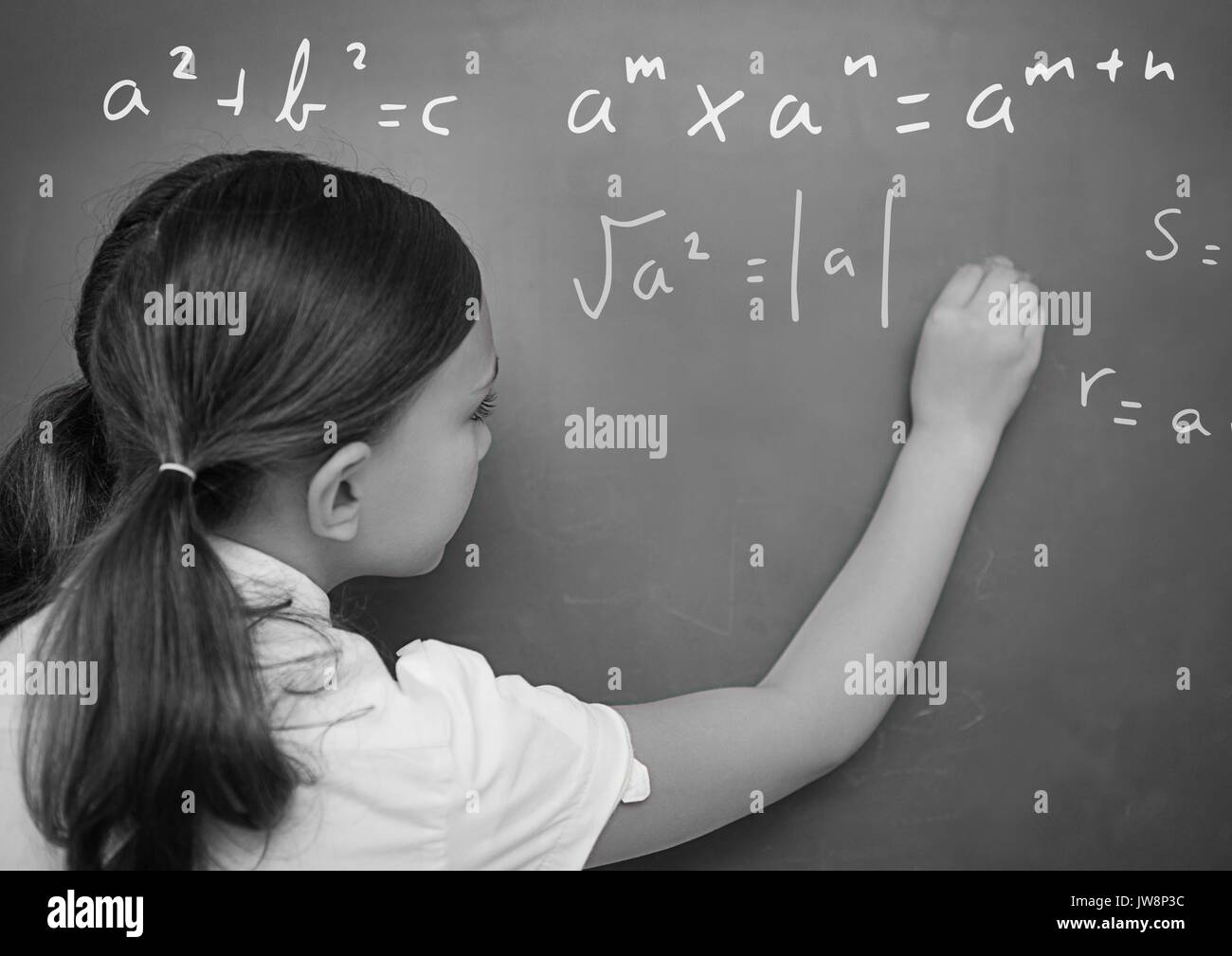 Digital composite of Girl writing math equations on blackboard Stock ...