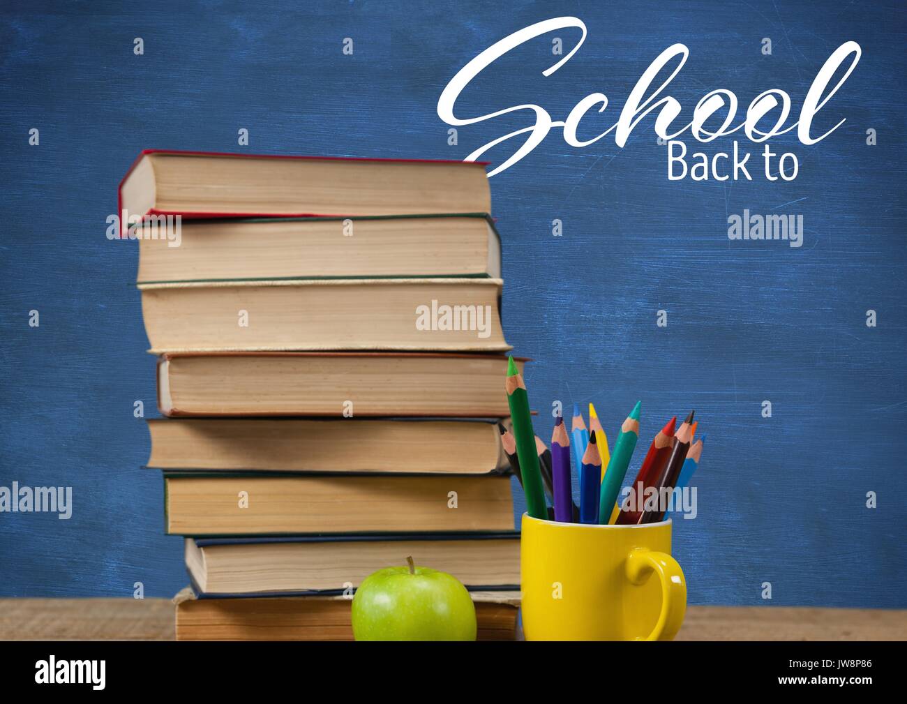 Digital composite of Back to School text on blackboard and Books on ...