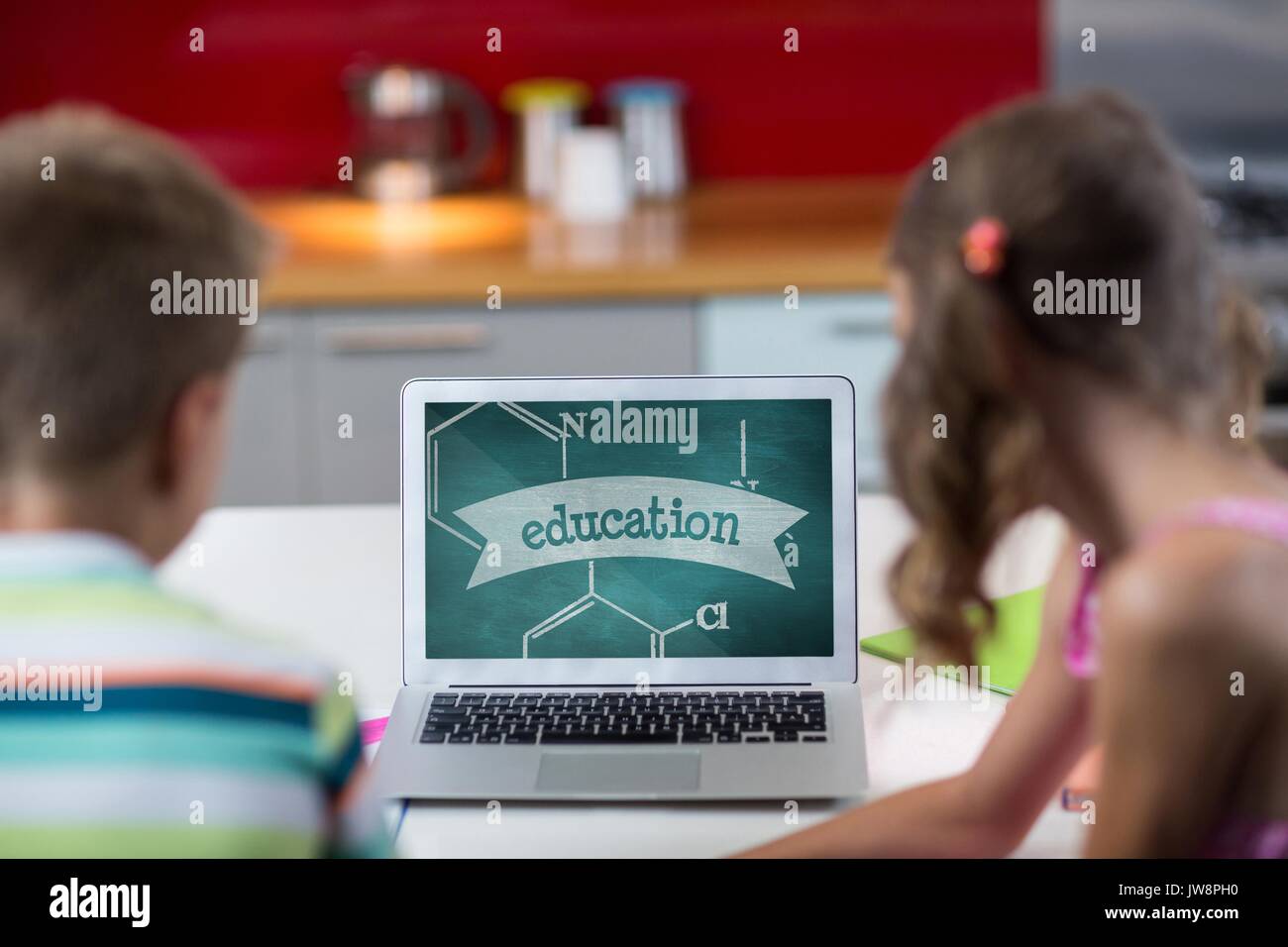 Digital composite of Kids looking at a computer with school icons on ...