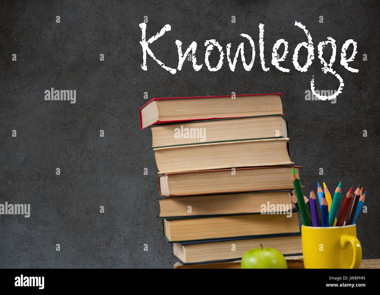 Digital composite of Knowledge text on blackboard with stack of books ...