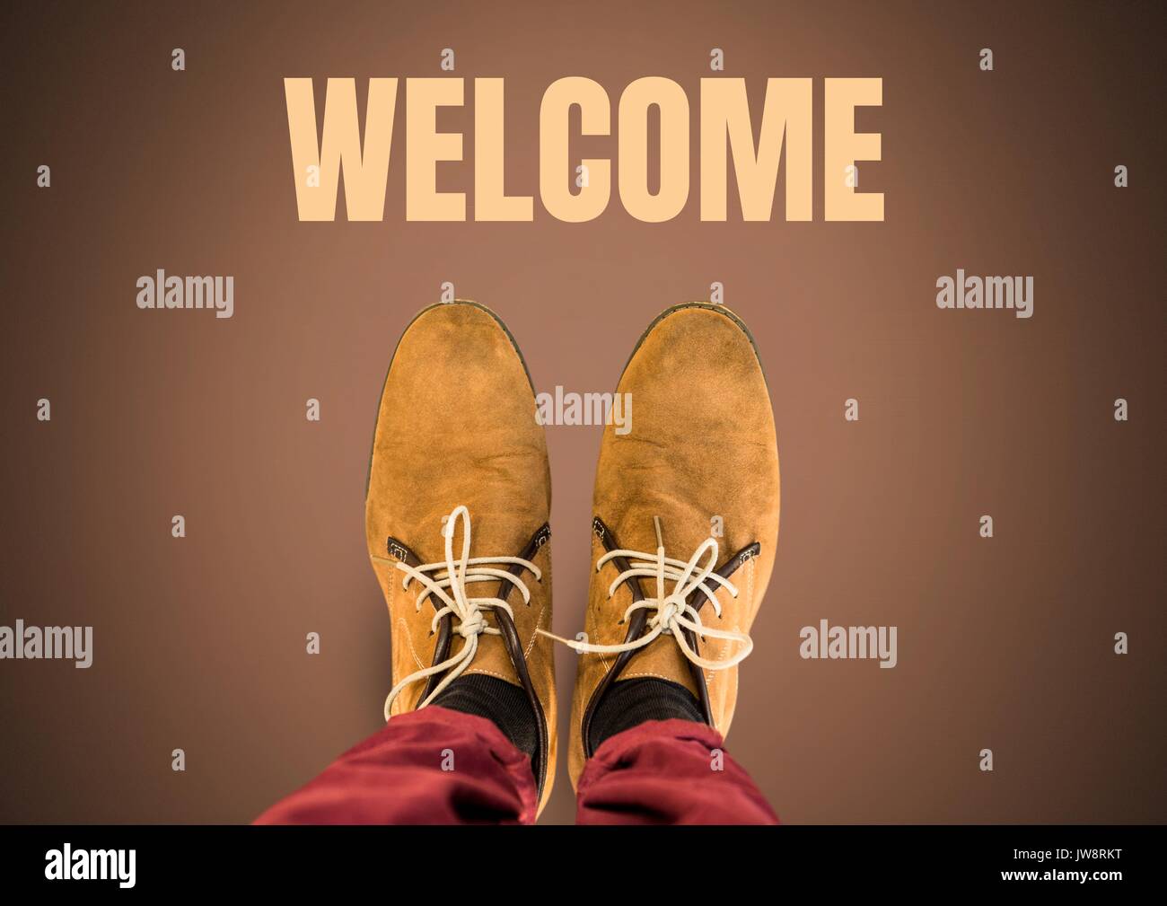Digital composite of Welcome text and Brown shoes on feet with brown ...