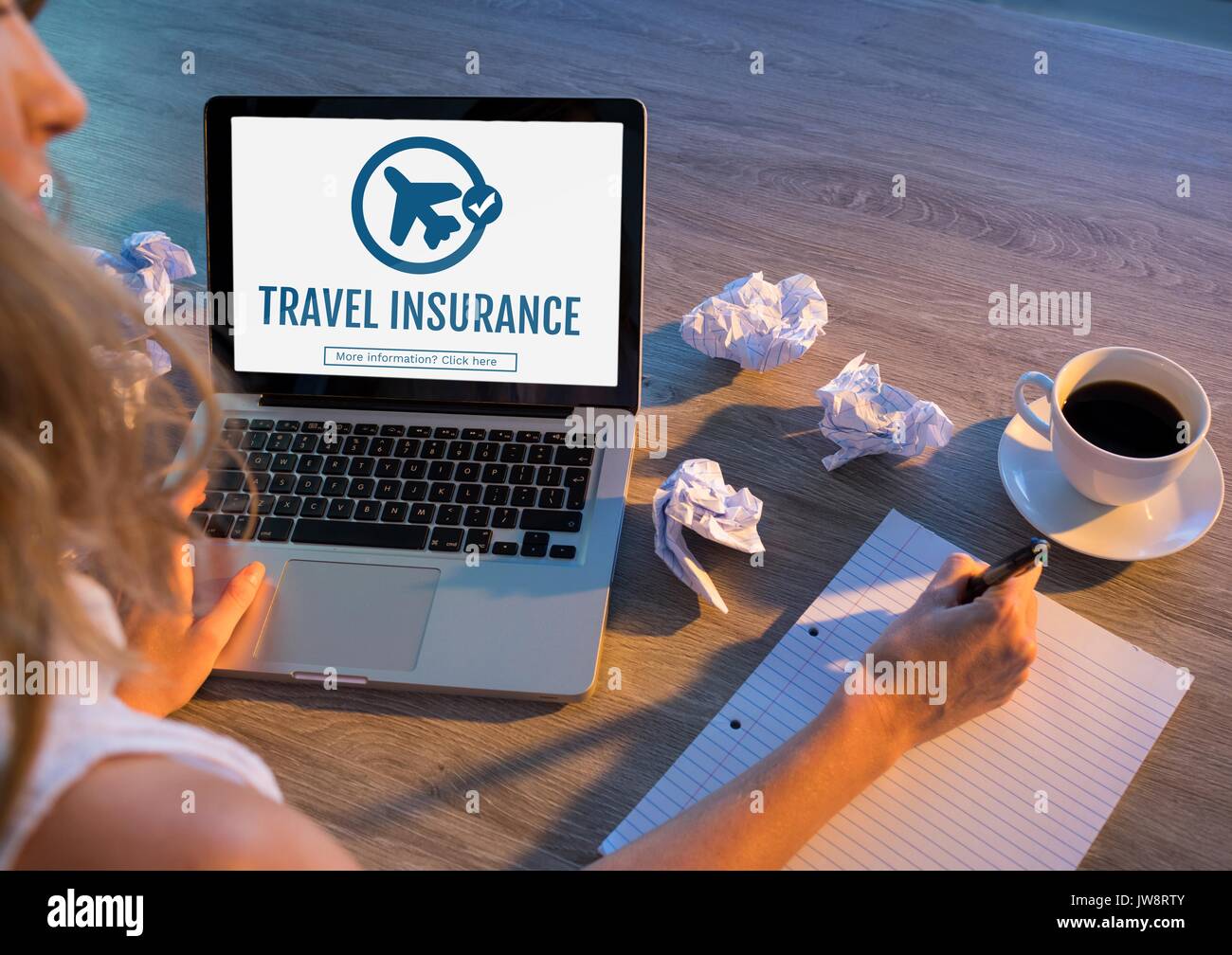 Digital composite of Woman using a computer with travel insurance ...