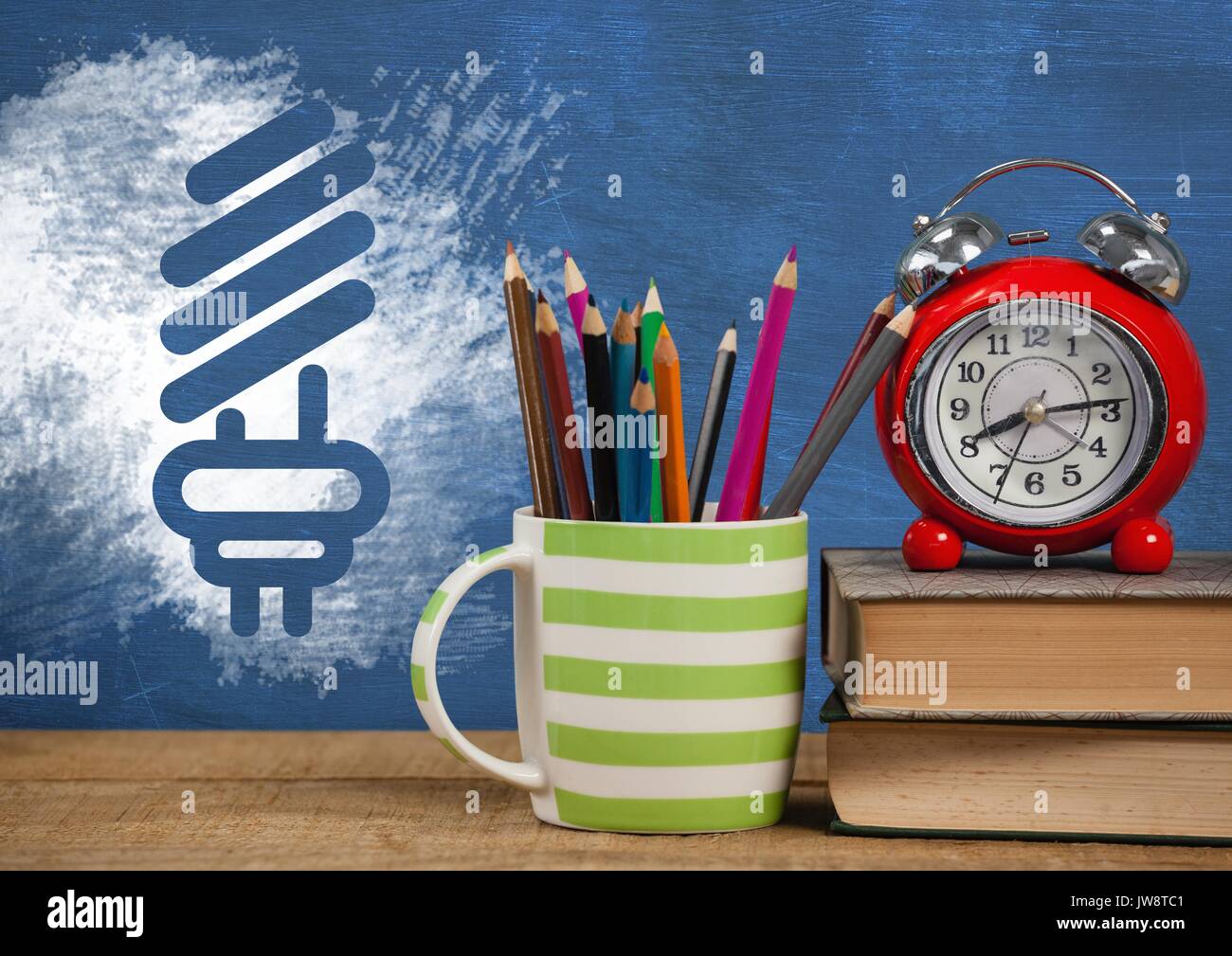 Digital composite of Desk foreground with blackboard graphics of light ...