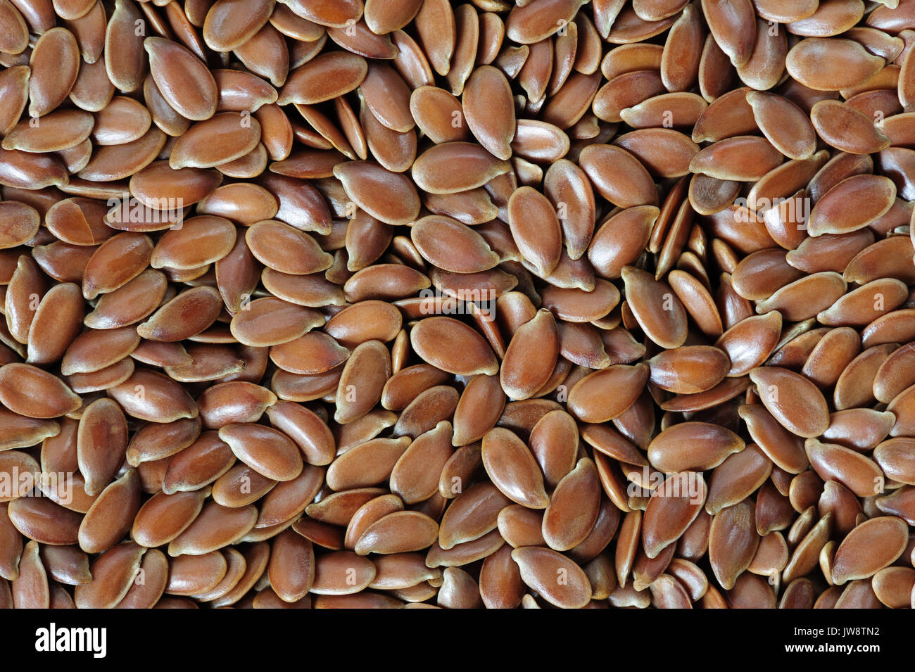 Brown flax seeds extreme closeup macro background Stock Photo - Alamy