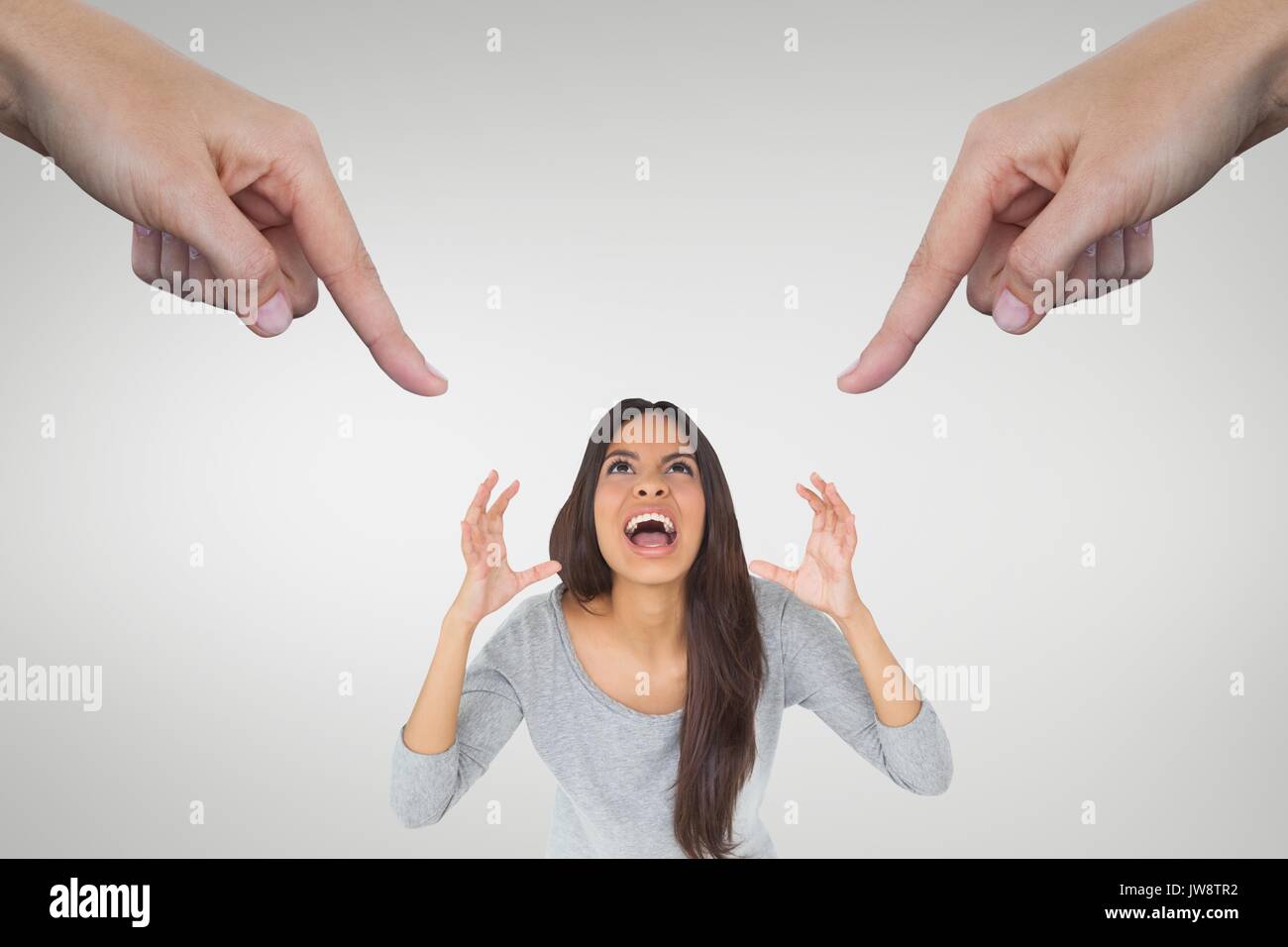 Digital composite of Hands pointing at angry woman against white ...