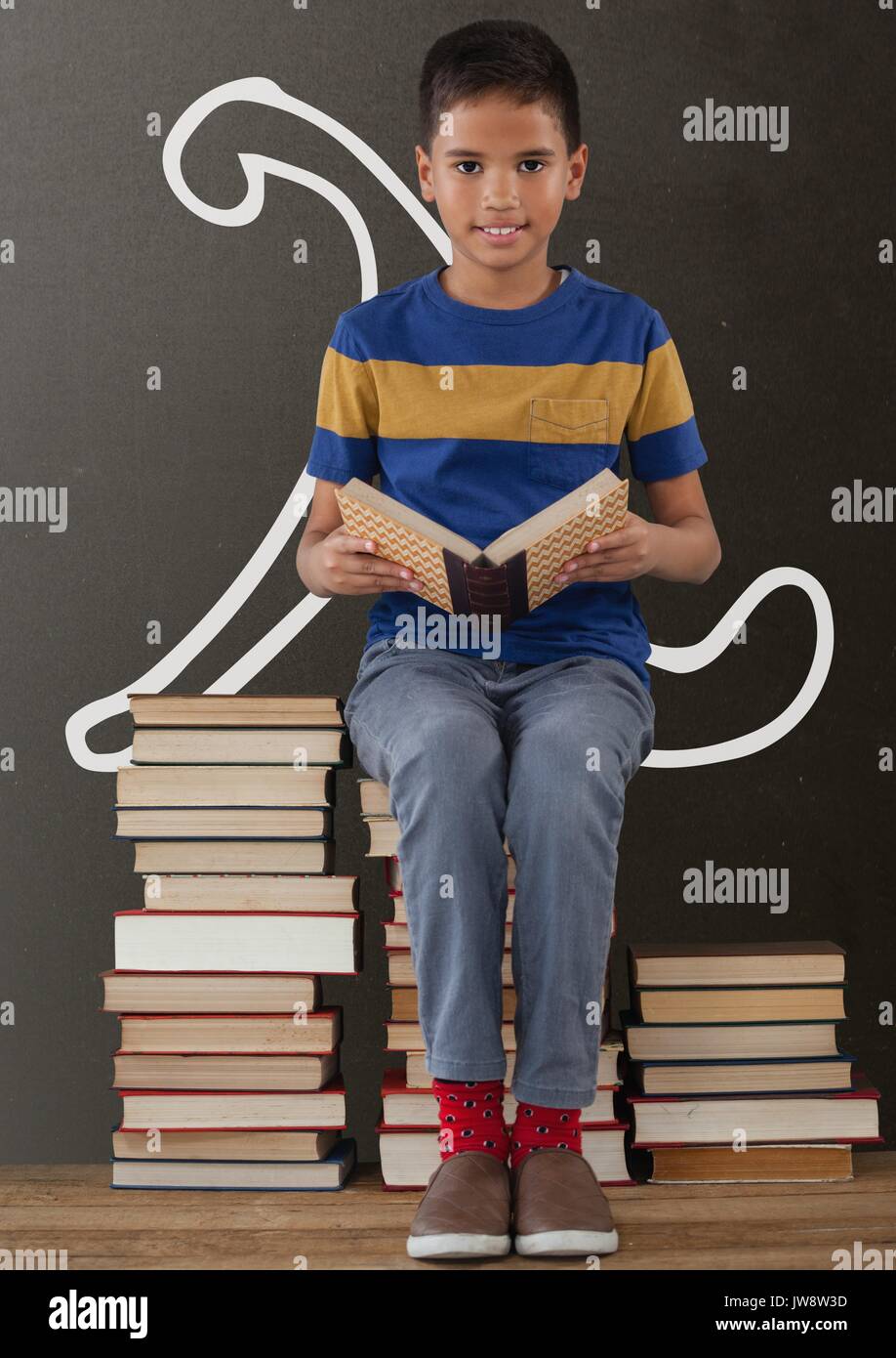 Digital composite of Student boy on a table reading against grey ...