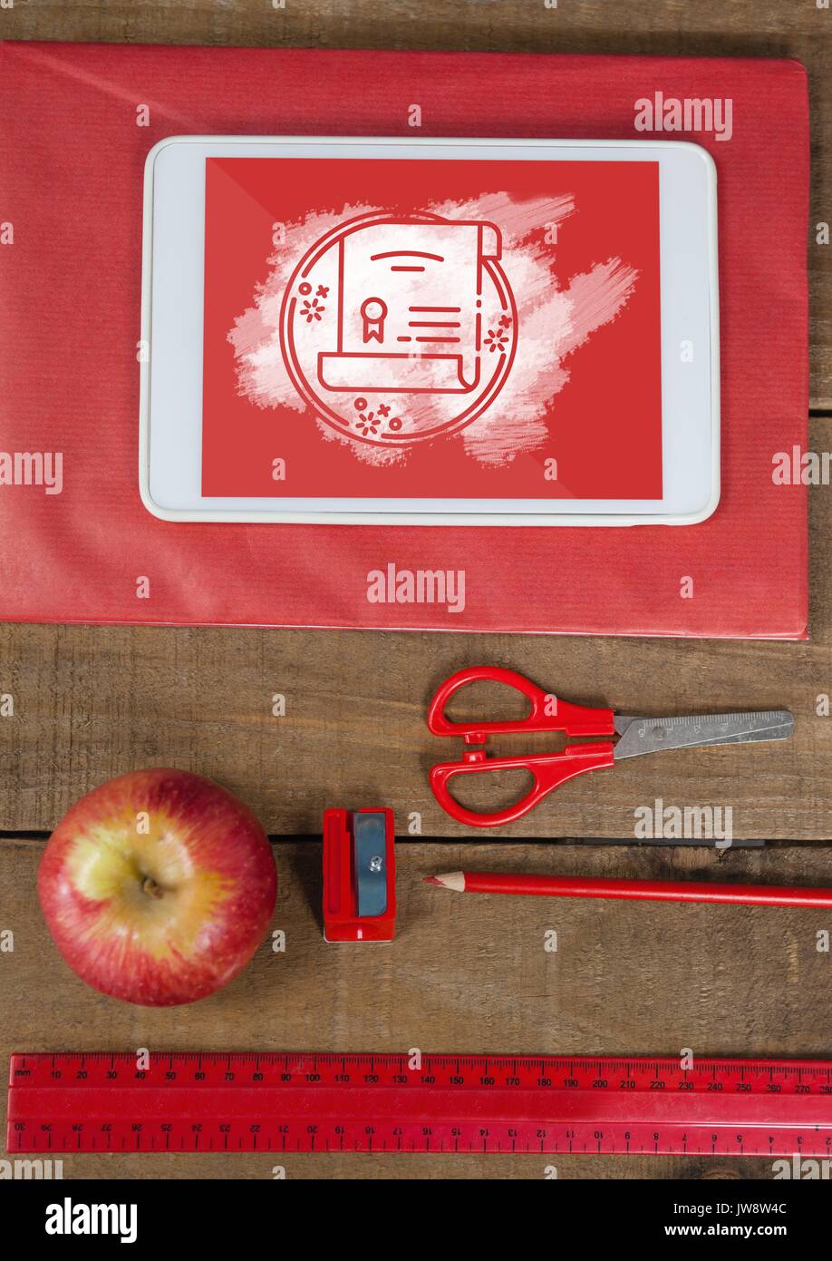 Digital composite of Tablet on a school table with school icons on ...