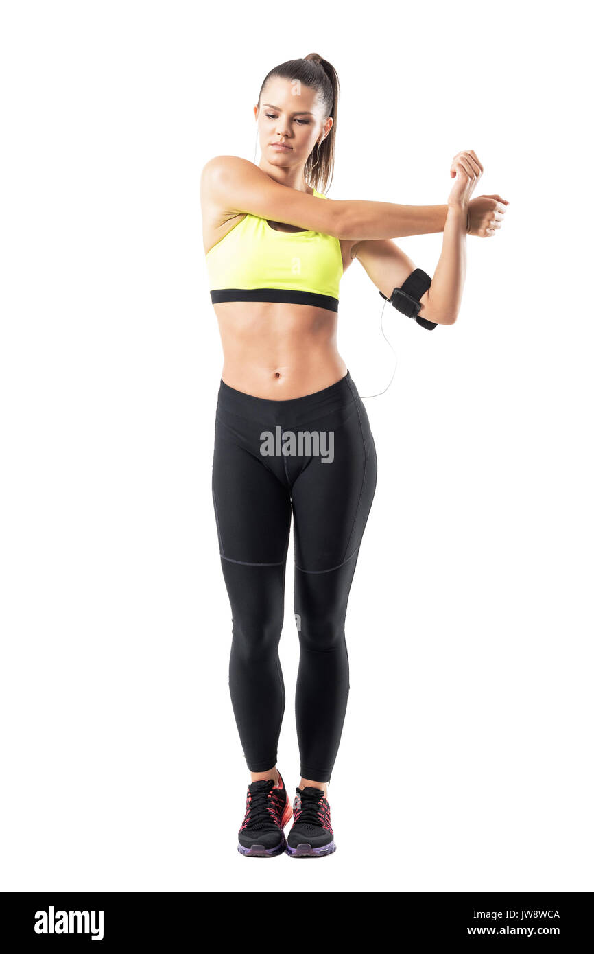 Pretty woman runner flexing shoulder exercise while stretching arm ...