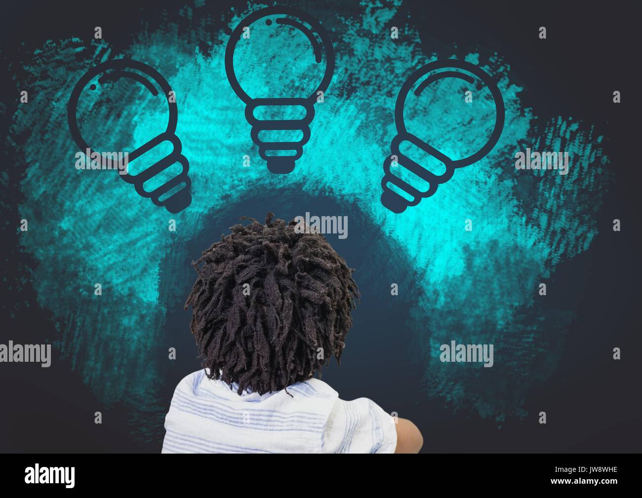 Digital composite of Boy looking at light bulb graphics Stock Photo - Alamy