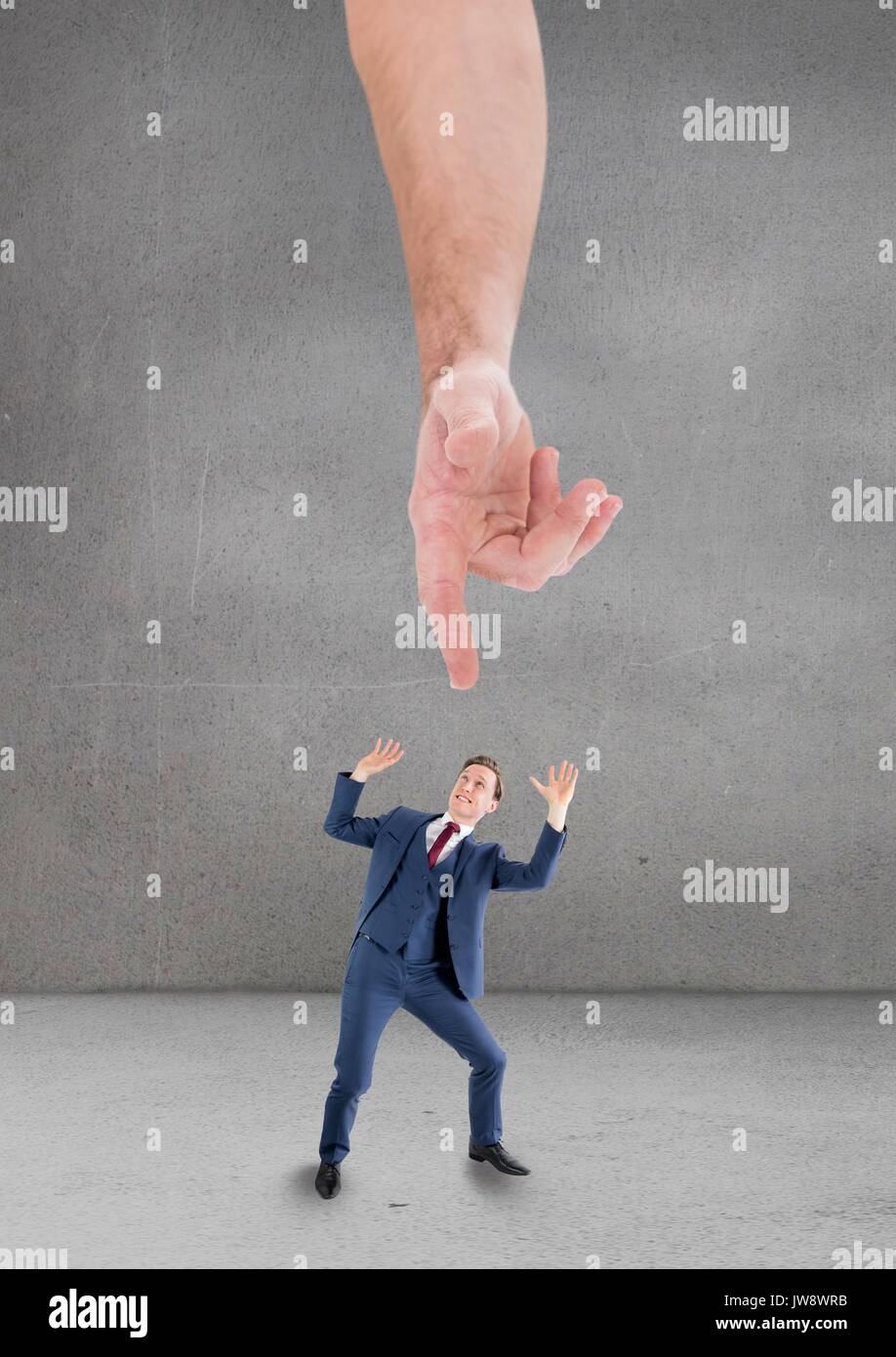 Digital composite of Hand pointing at scared business man against grey ...