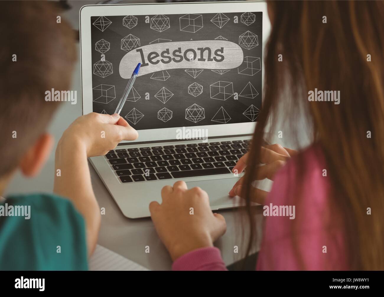 Digital composite of Kids using a computer with school icons on screen ...