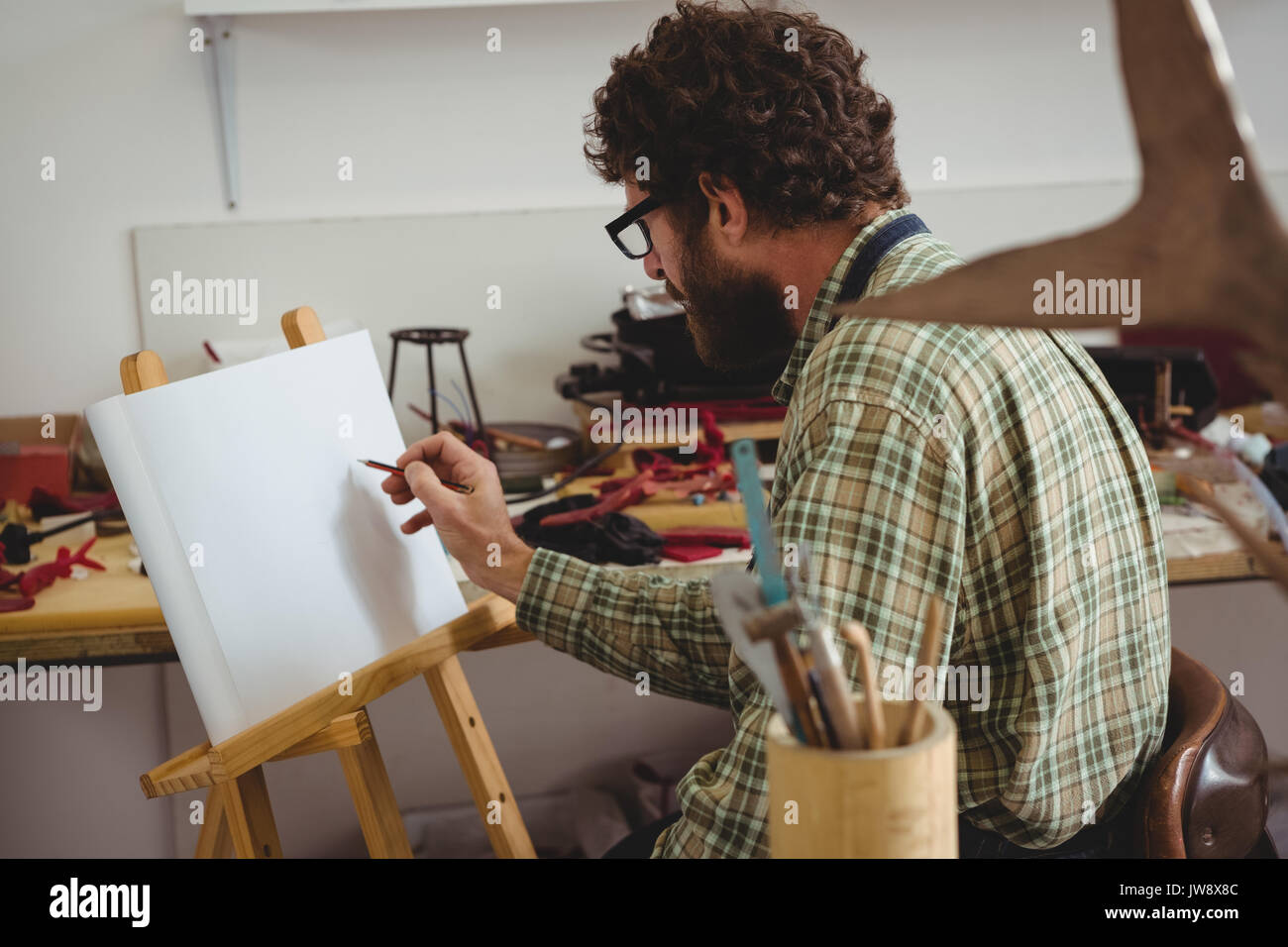 Craftsman drawing sculpture design in workshop Stock Photo - Alamy