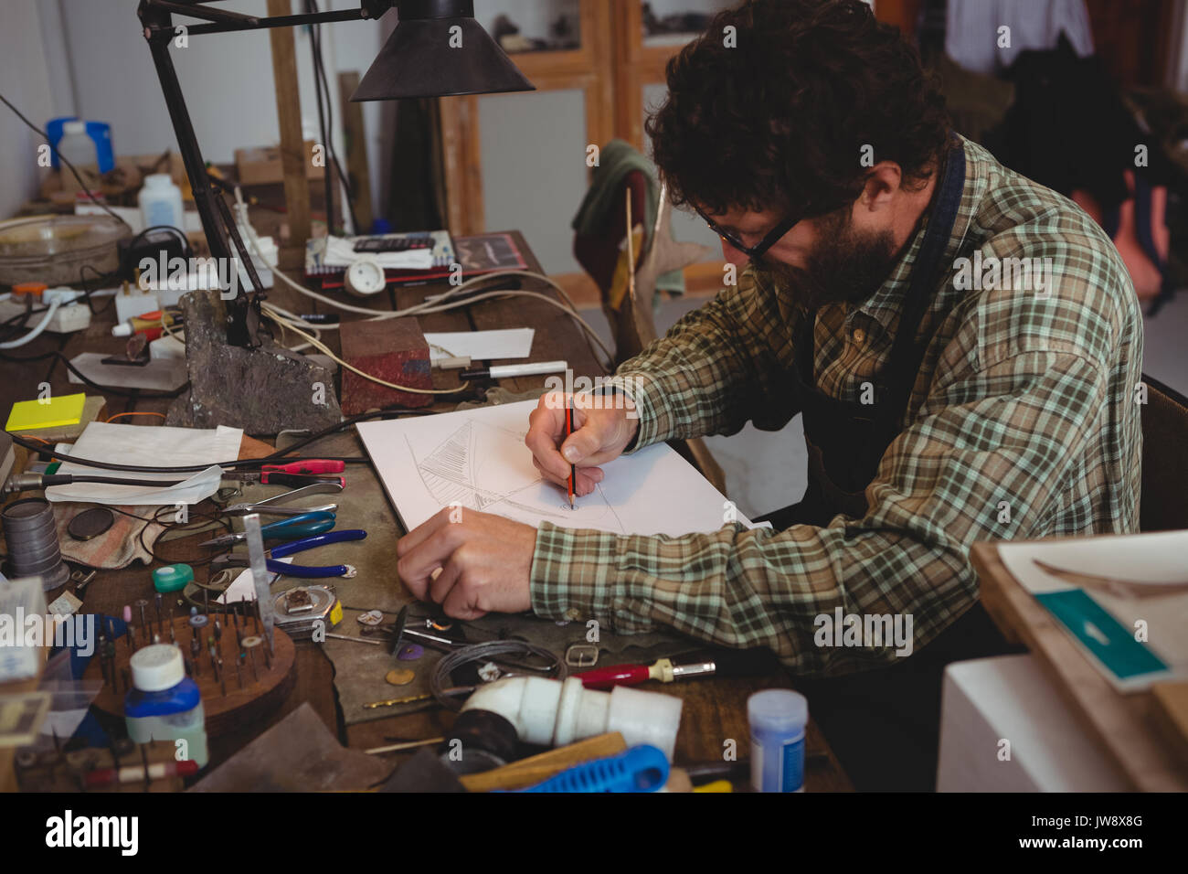 Craftsman drawing sculpture design in workshop Stock Photo - Alamy
