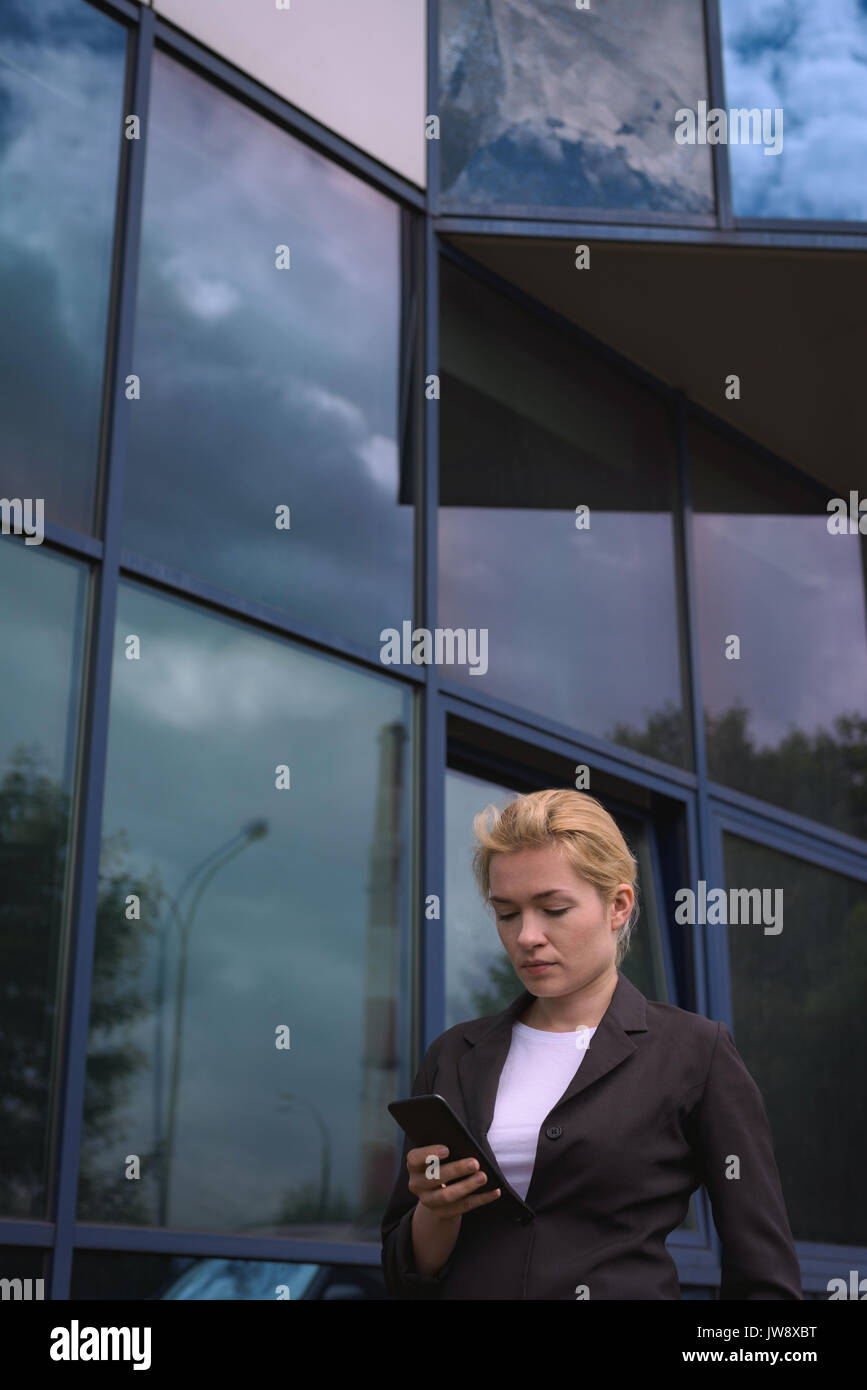 University student using mobile phone in campus Stock Photo - Alamy