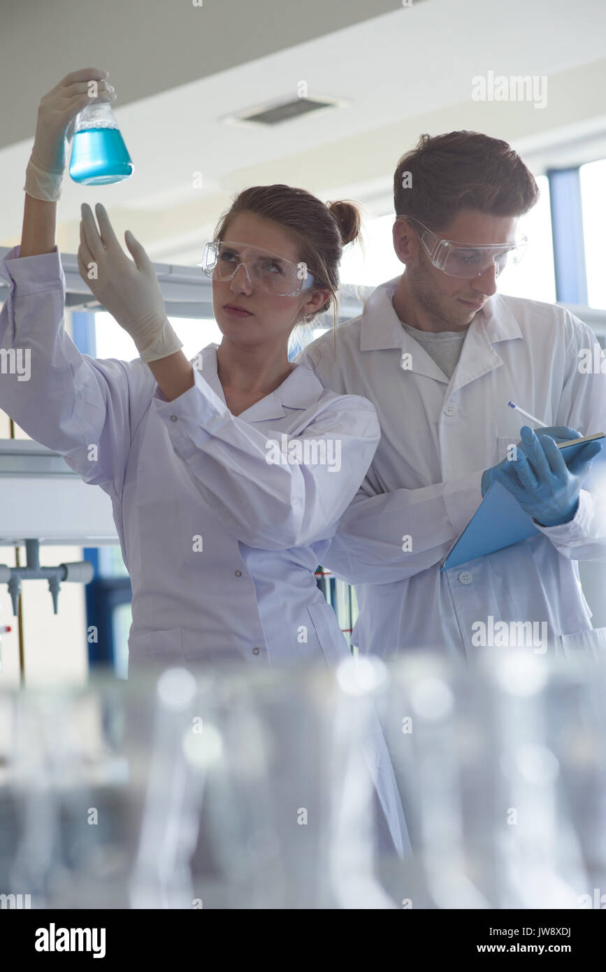 Young college students practicing chemistry experiment in lab Stock ...