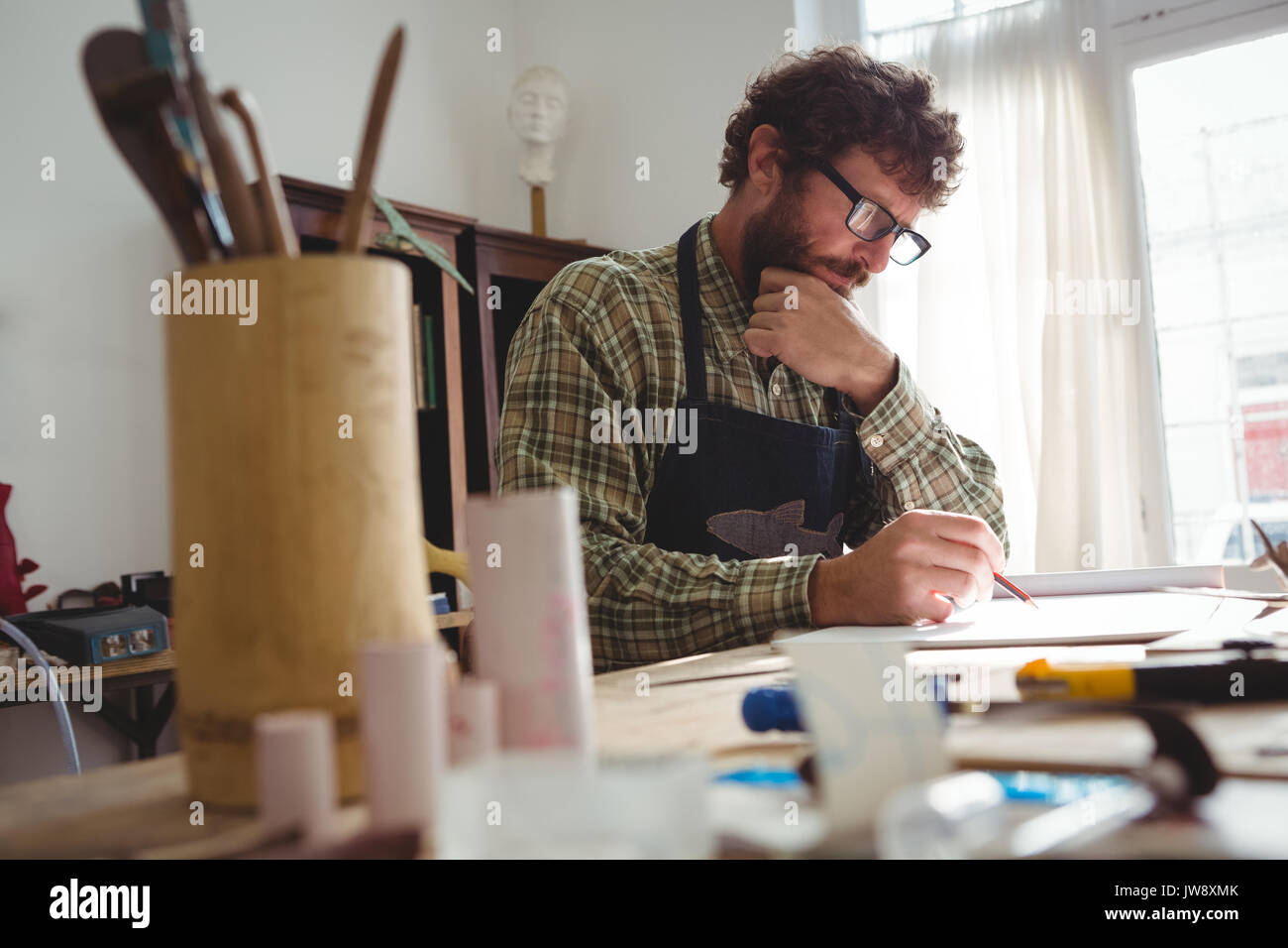Craftsman drawing sculpture design in workshop Stock Photo - Alamy
