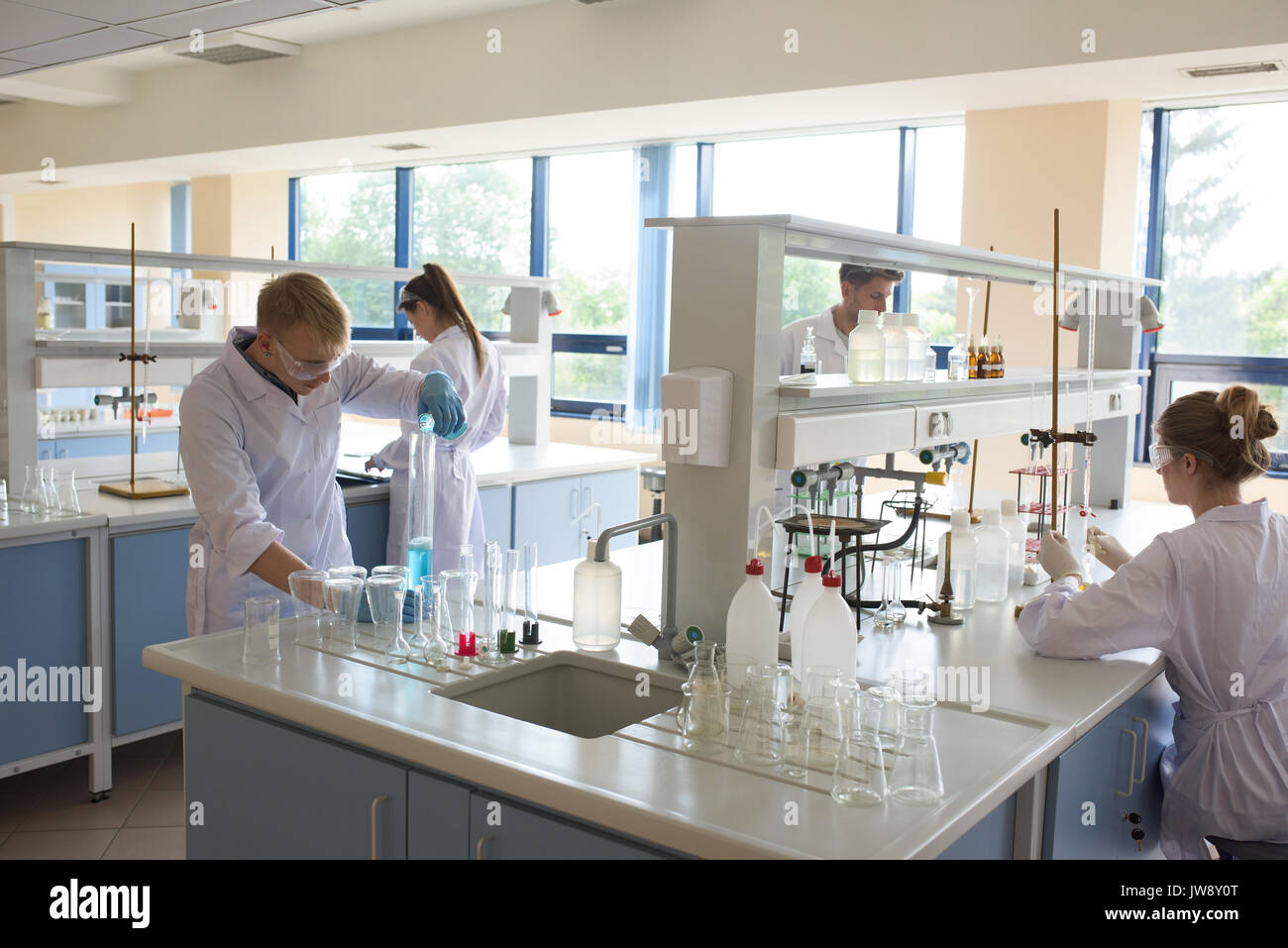 University students practicing experiment in lab Stock Photo - Alamy