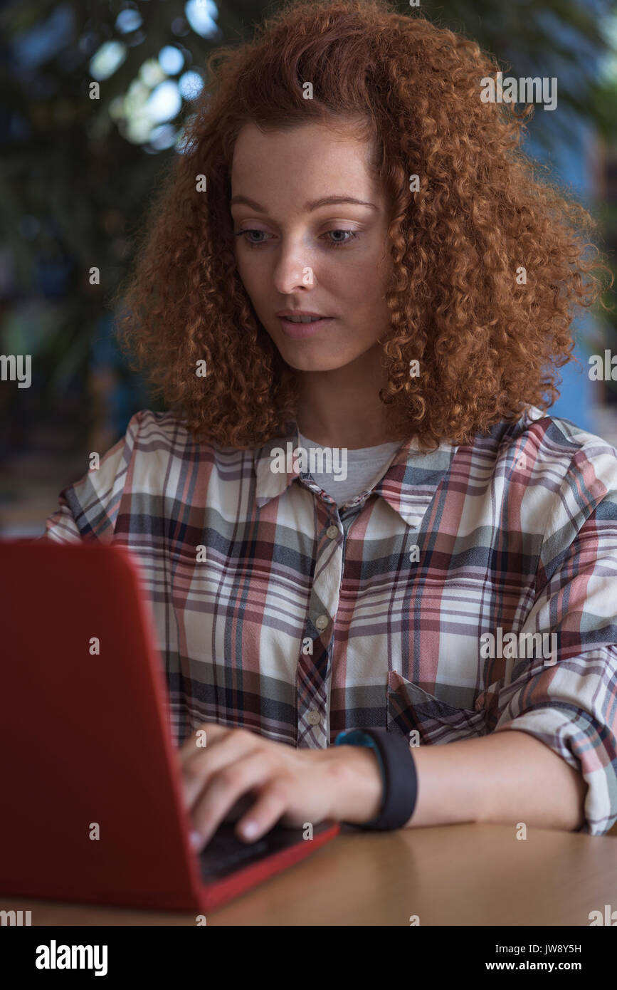 Teenage girl using laptop computer while sitting in classroom Stock ...