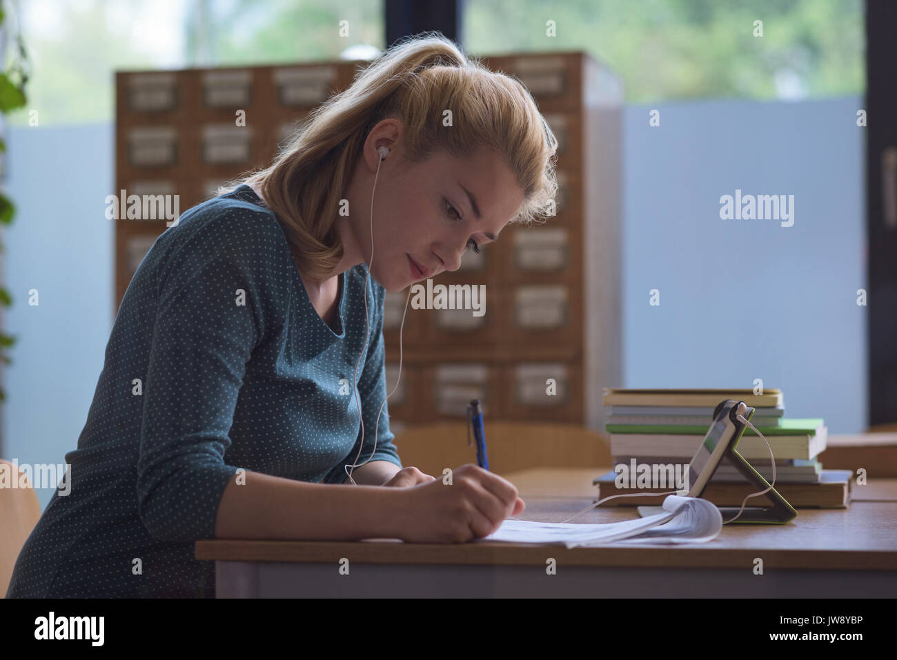 University student completing assignment in class at college Stock ...