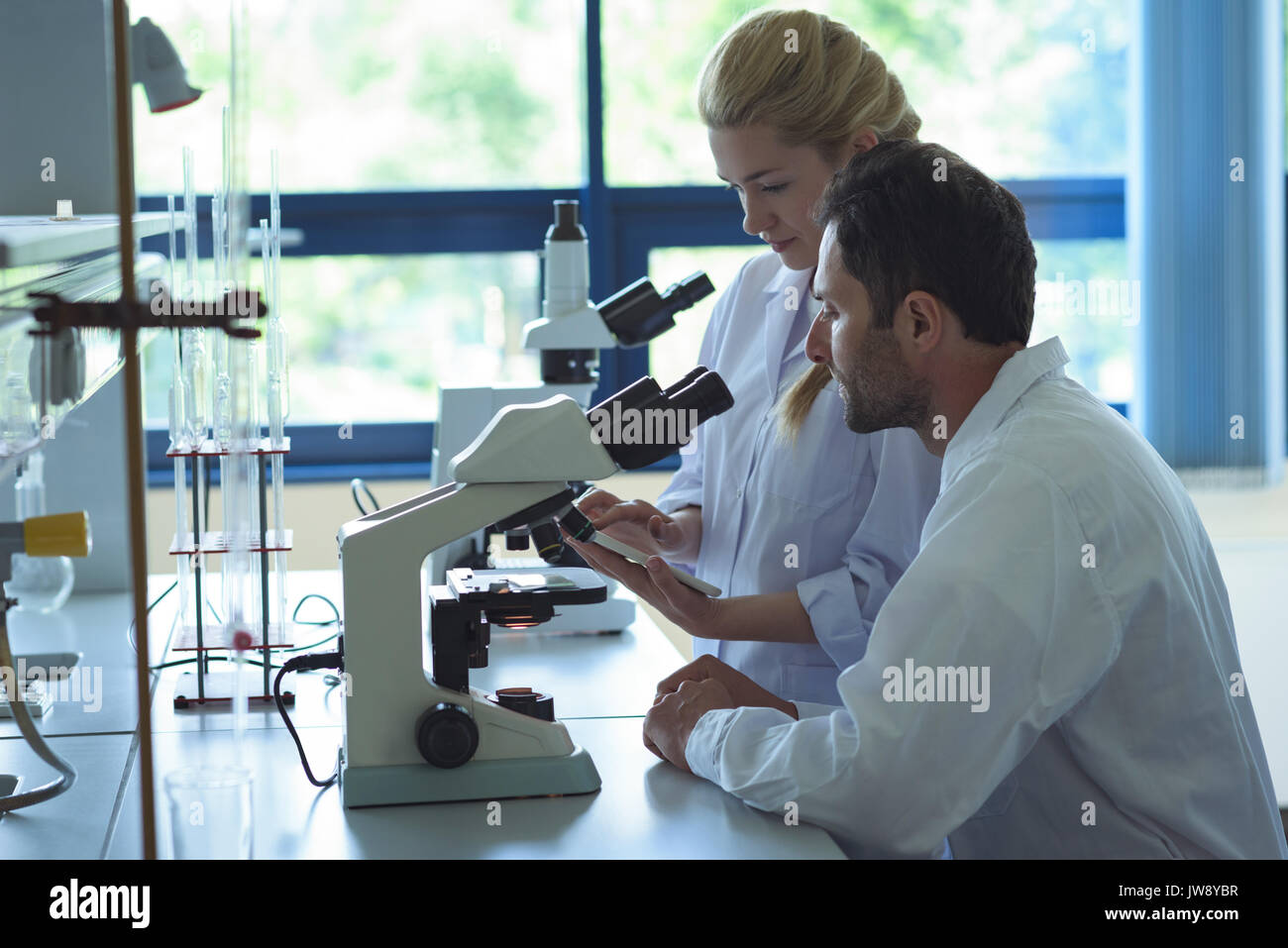 Students using microscope hi-res stock photography and images - Alamy