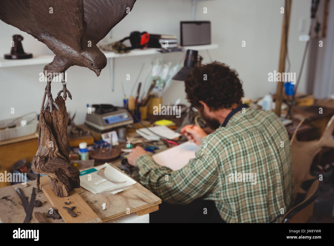 Craftsman drawing sculpture design in workshop Stock Photo - Alamy