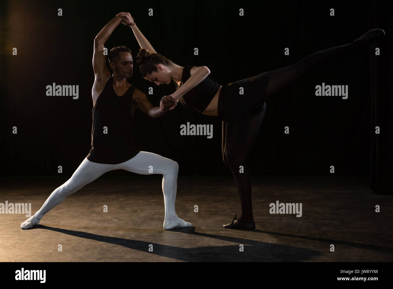Ballet partners practicing ballet dance in stage Stock Photo - Alamy