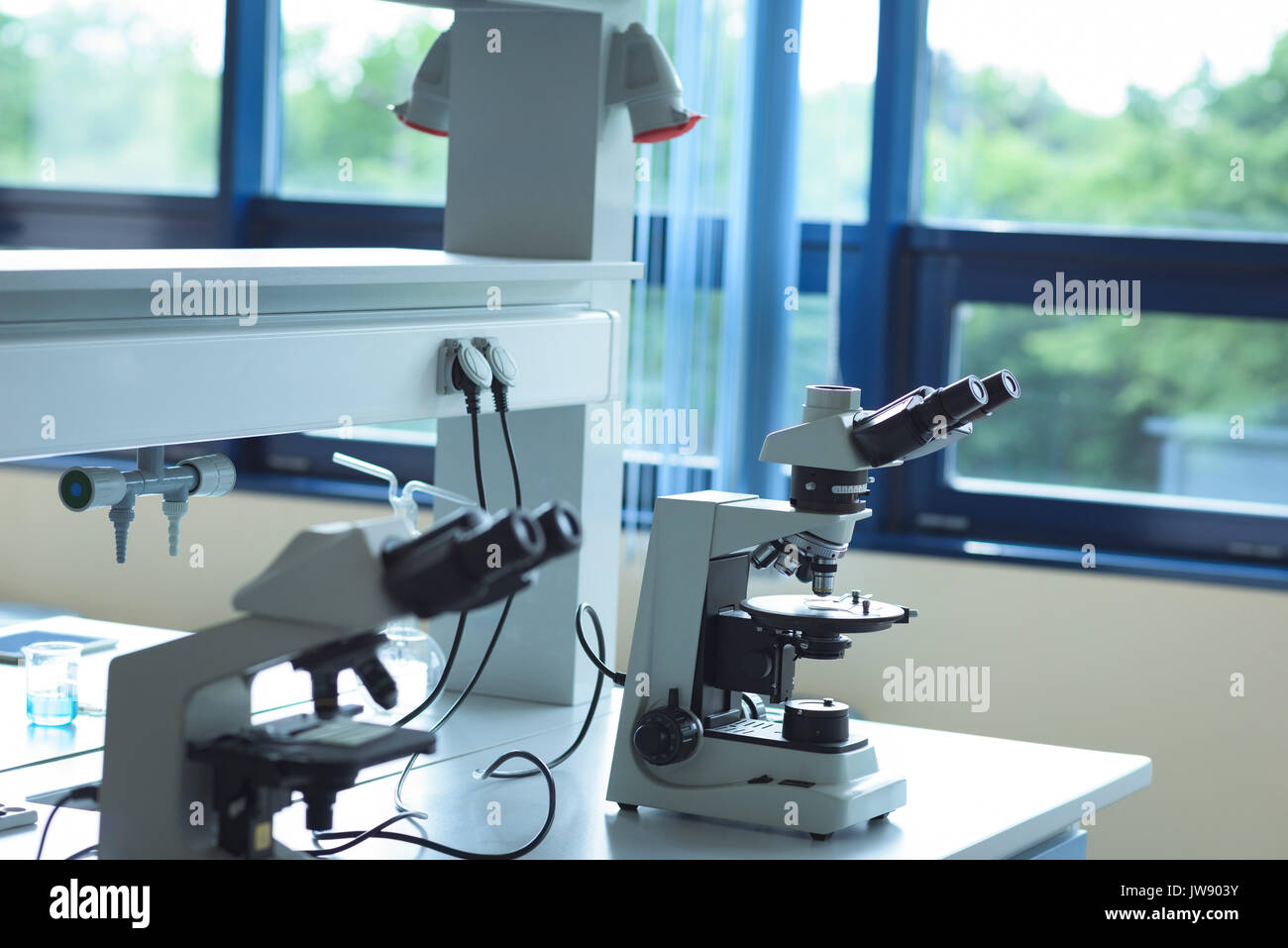 Microscope on table in laboratory Stock Photo - Alamy