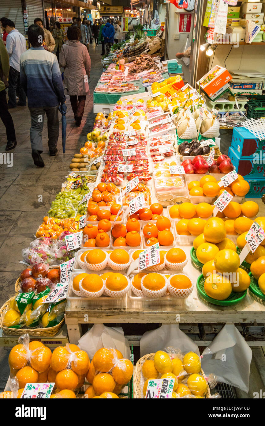 View along fruit stall with fresh oranges, apples and other fruits in ...