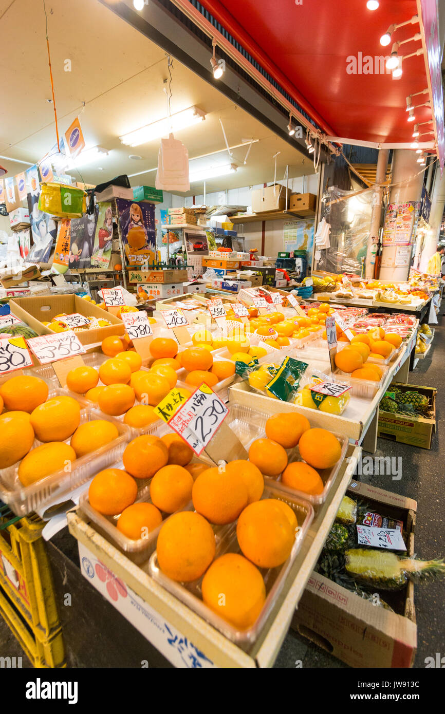 Low angle view of fruit stall with boxes of fresh oranges and other ...
