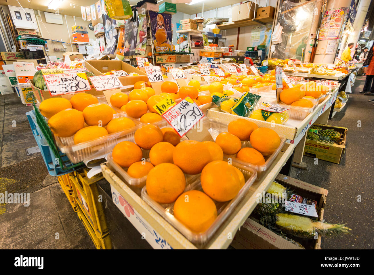 Low angle view of fruit stall with boxes of fresh oranges and other ...