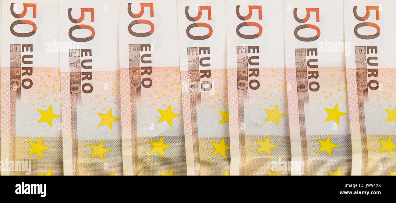 Aligned banknotes 50 euro european money on white background. Front and ...