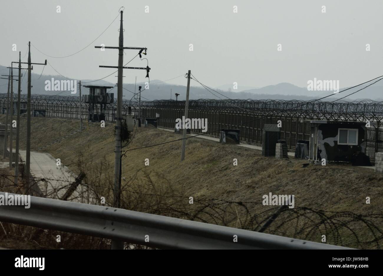 Camouflaged South Korean military buildings are seen along the fenced ...