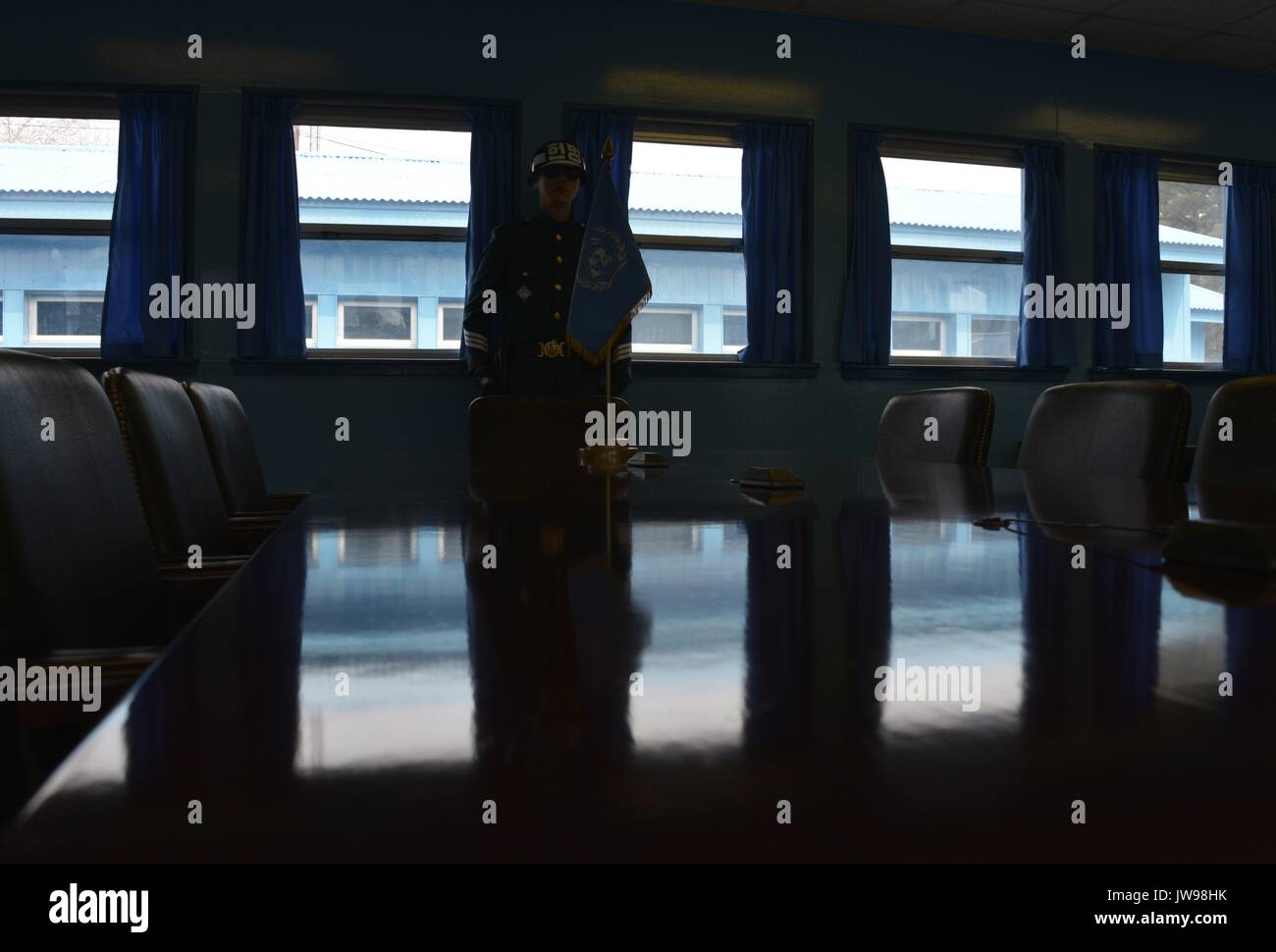 A South Korean soldier stands right at the concrete marked line ...