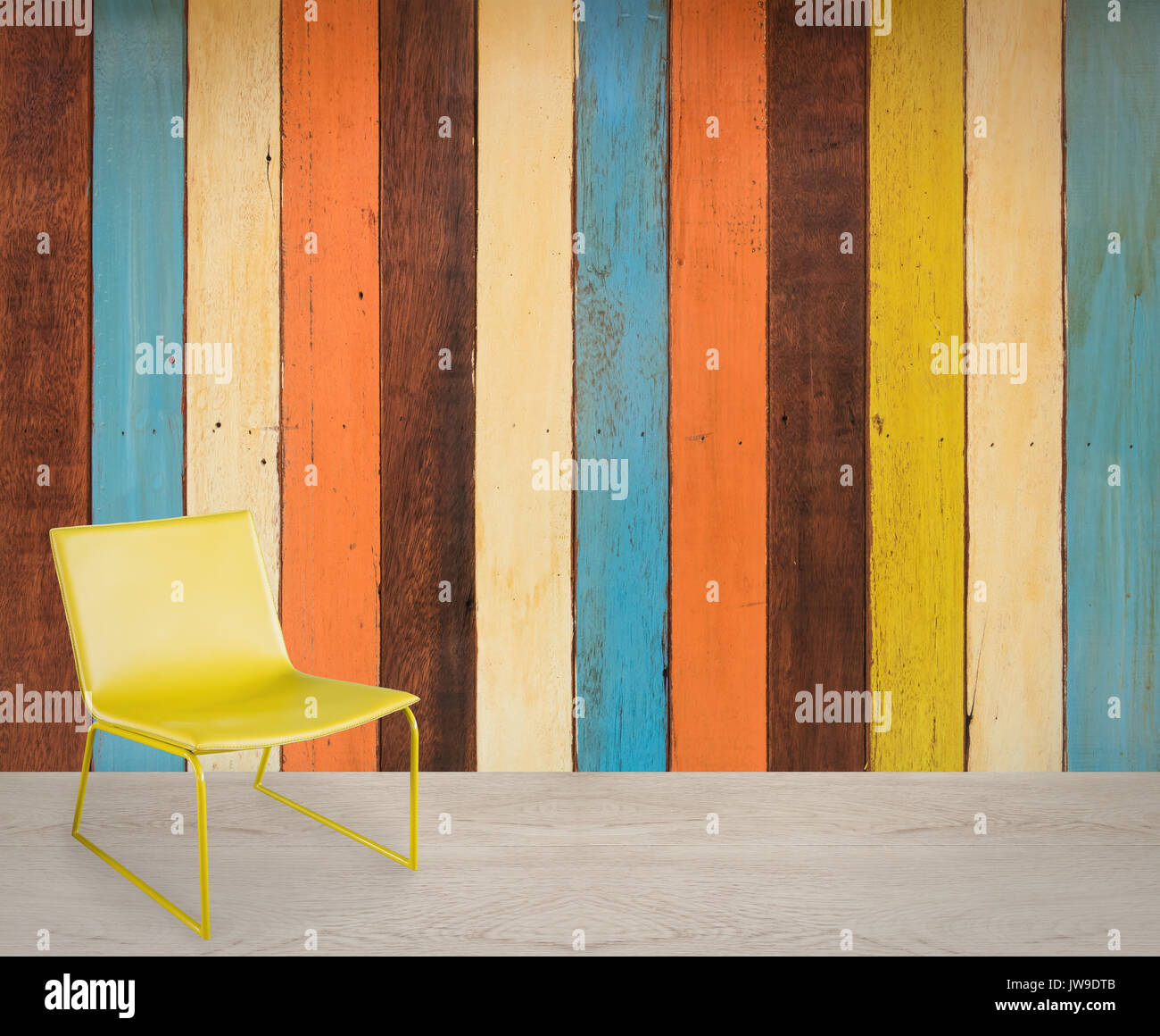 living area with yellow chair and colorful background Stock Photo - Alamy