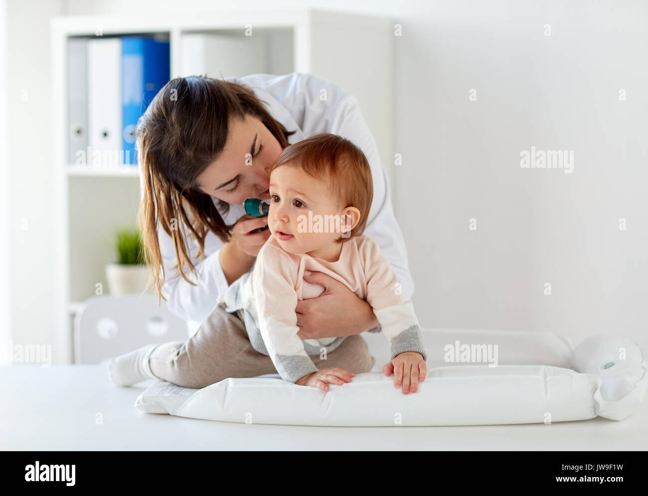 doctor with otoscope checking baby ear at clinic Stock Photo - Alamy