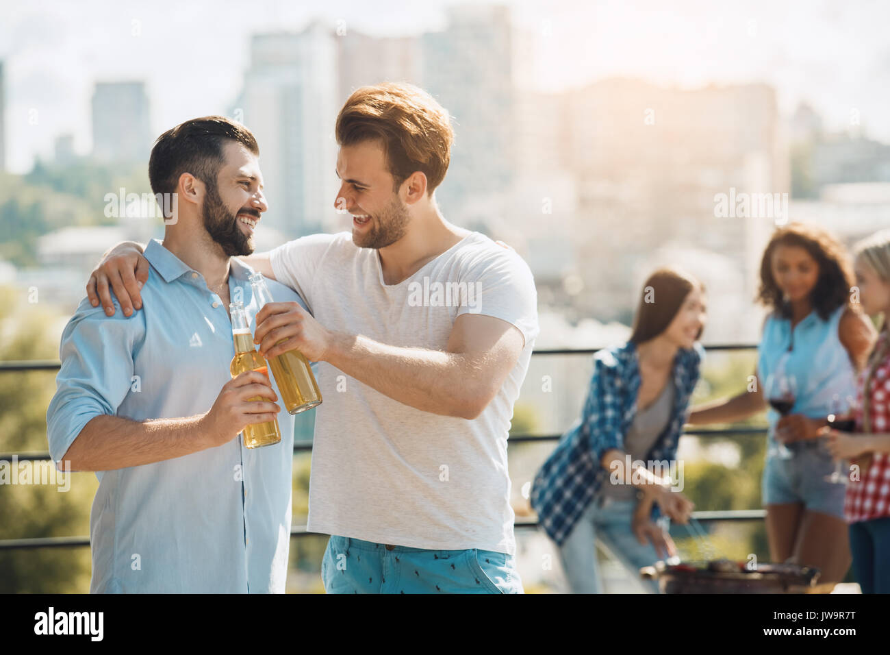 Group of people having barbecue party drinking beer Stock Photo - Alamy