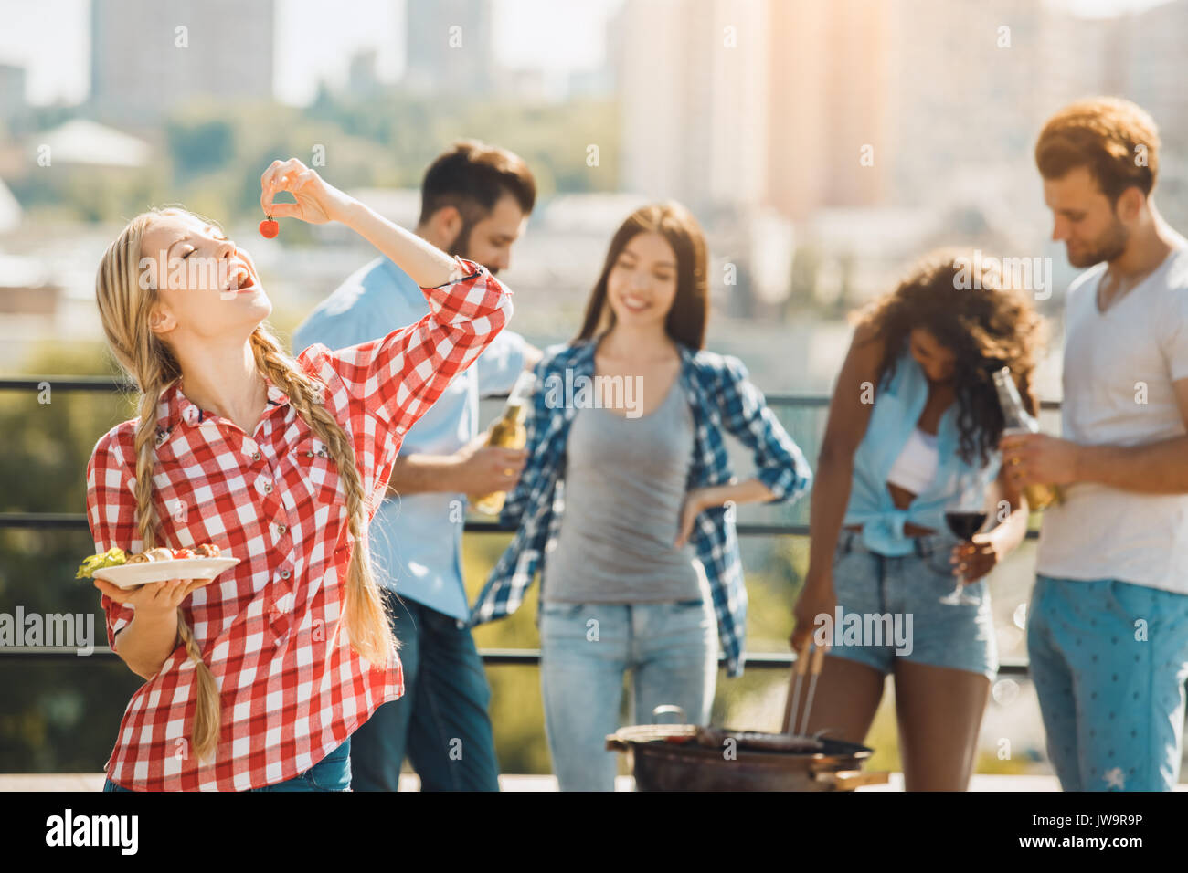 Group of people having barbecue party cooked dish Stock Photo - Alamy