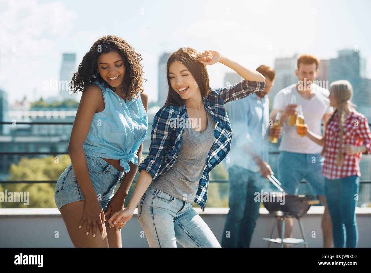 Group of people having barbecue party dancing Stock Photo - Alamy