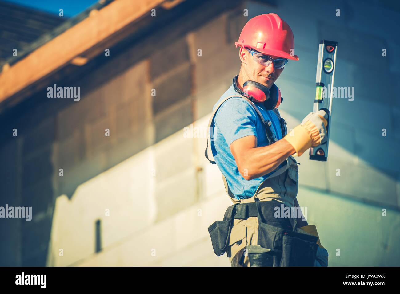 Construction Worker with Level Tool and the Construction Site Stock ...