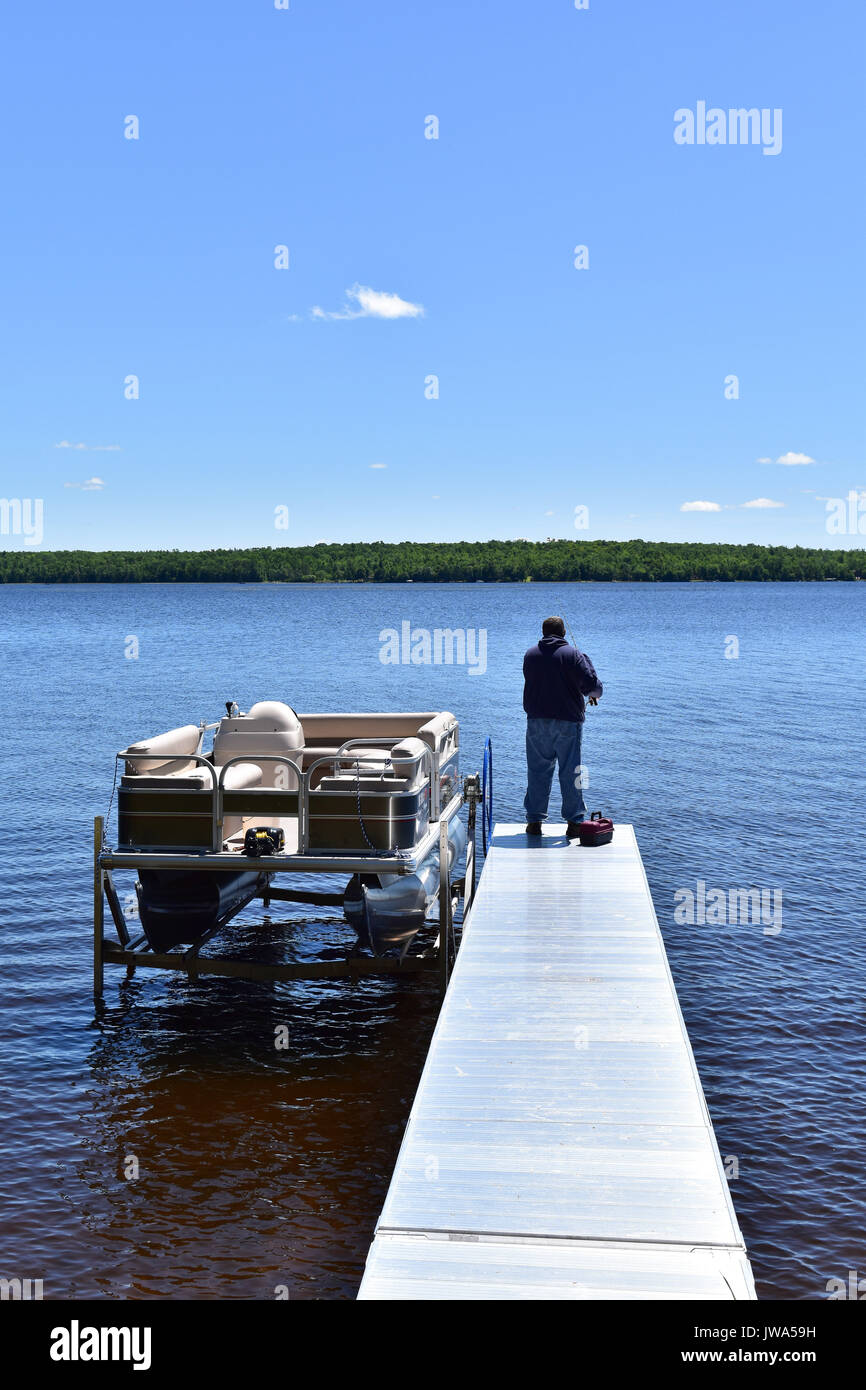 Man fishing off a pier hi-res stock photography and images - Alamy