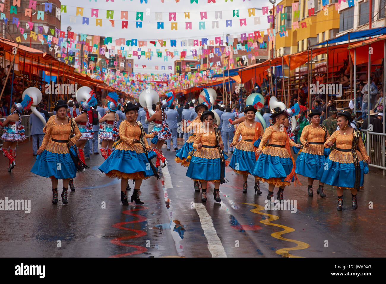 Morenada dance group in colourful outfits parading through the mining ...