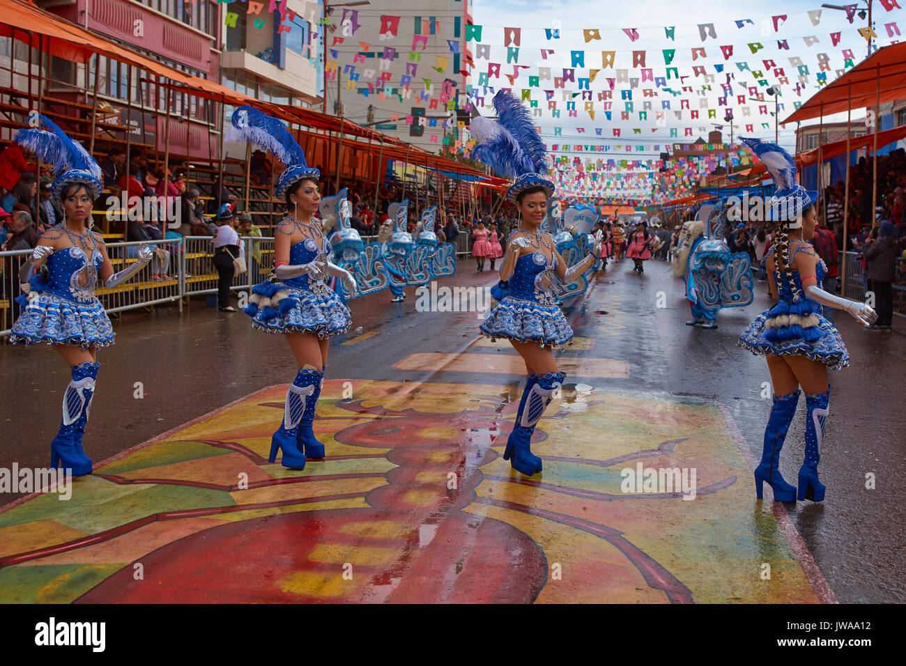 Morenada dance group in colourful outfits parading through the mining ...