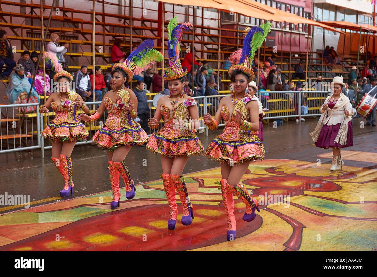 Morenada dance group in colourful outfits parading through the mining ...