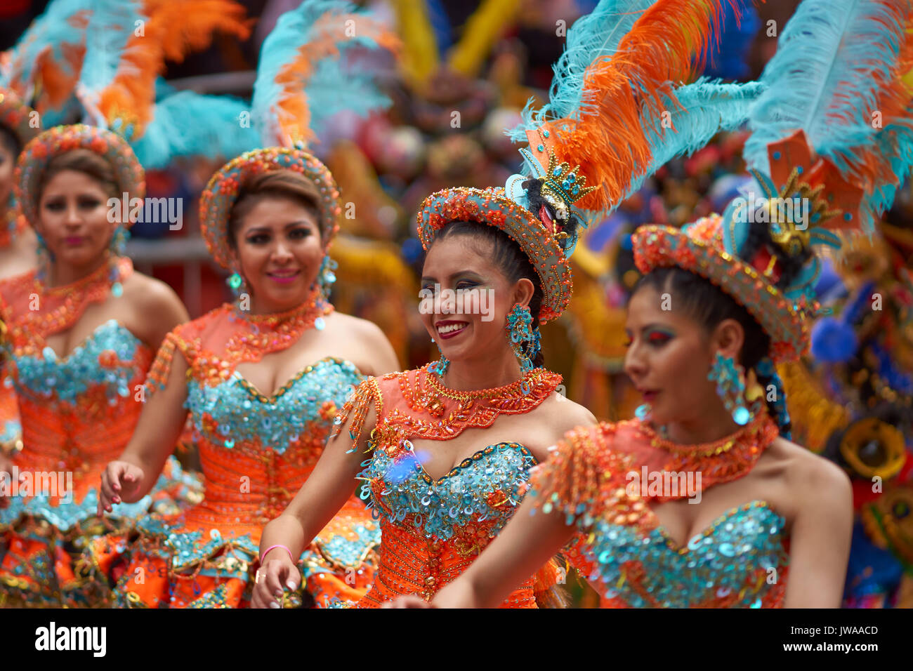 Morenada dance group in colourful outfits parading through the mining ...